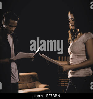 Actors reading their scripts on stage Stock Photo - Alamy