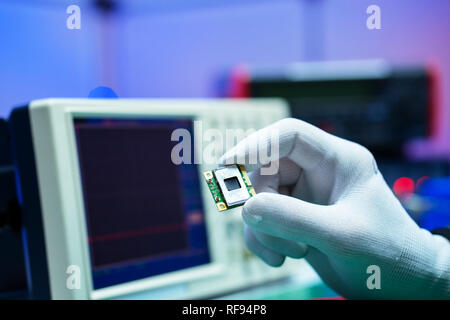 Hand with small electronic microchip microcontroller Stock Photo - Alamy