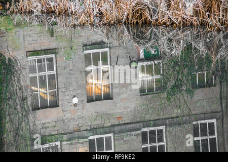 The stone built 18th. century Viyella textile mill with mist forming on ...