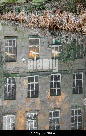The stone built 18th. century Viyella textile mill with mist forming on ...