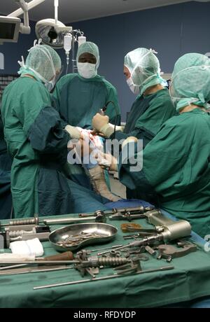 Knee replacement surgery. Surgical team performing a total knee ...