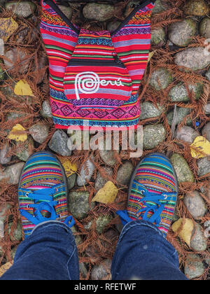 Peruvian, colorful shoes on a background of stones covered with brown ...