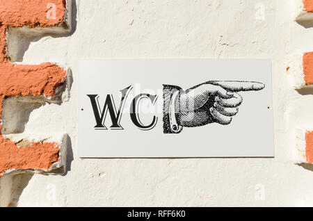 Vintage toilet sign with pointing hand Stock Photo - Alamy