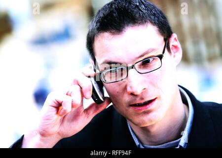 DEU Germany Man with a mobile phone in an office Stock Photo - Alamy