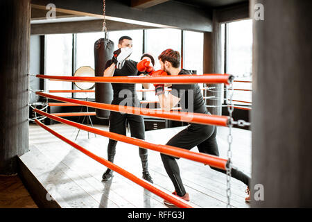 Professional trainer in boxing gym Stock Photo - Alamy