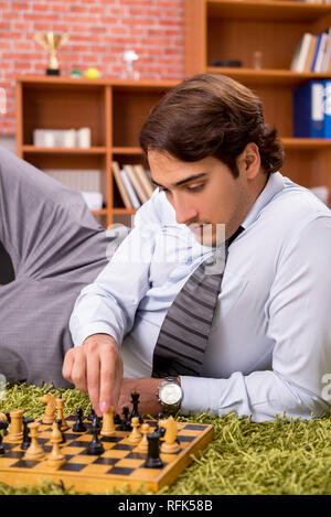 Young handsome boss playing chess during break Stock Photo - Alamy