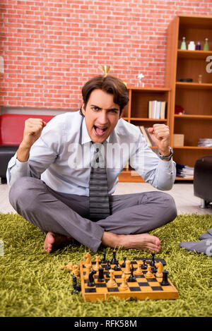 Young handsome boss playing chess during break Stock Photo - Alamy