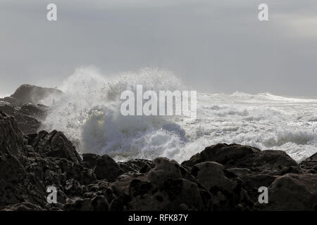 Detailed big splash from waves against beach rocks. North of Portugal ...
