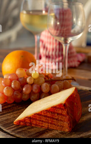 Fresh green sea grapes served in a sleek black bowl, surrounded by red ...