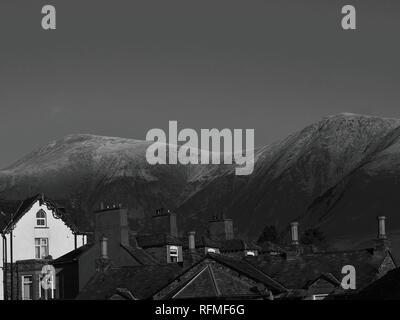 The roofs of Portinscale with the mountain of Skiddaw behind ...