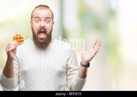 amazed cheerful hipster with beard holding coffee cup on yellow ...