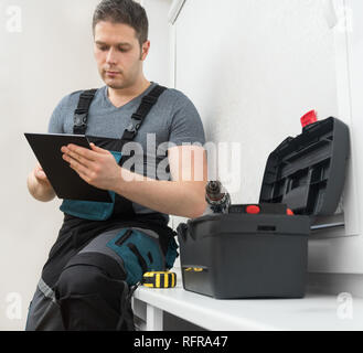 builder with tablet pc and equipment indoors Stock Photo - Alamy