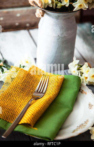 Festive table setting for Easter with fork, knife and tulip on spring ...