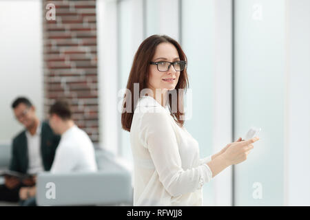 Businesswoman standing in the lobby of a large business center Stock ...