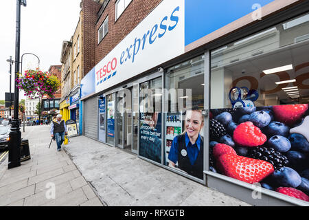 An exterior sign of a Tesco Metro supermarket in Levenshulme, Greater ...