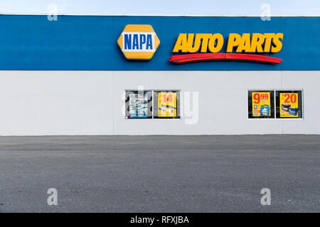 A logo sign outside of a NAPA Auto Parts retail store location in ...