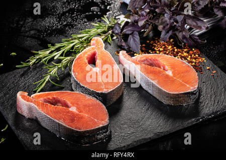 Pices of red fish and greenery on a studio background Stock Photo - Alamy