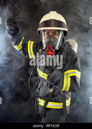 Firefighter wearing protective suit, helmet and mask Stock Photo - Alamy