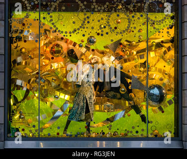 Colorful window display in a clothing store with three mannequins and ...