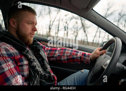 The young man behind the wheel driving car Stock Photo - Alamy