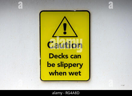 Caution warning sign slippery deck dangerous wet Stock Photo - Alamy