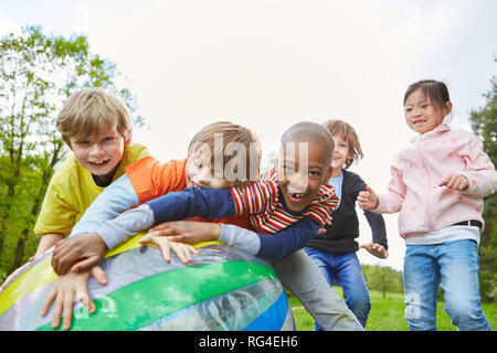 Interracial group of kids playing at the park Stock Photo - Alamy