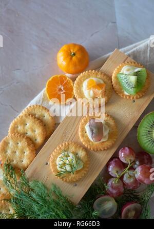 Biscuit Canape serving on wooden board Stock Photo - Alamy