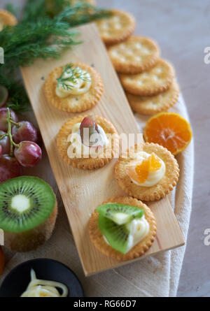 Biscuit Canape serving on wooden board Stock Photo - Alamy