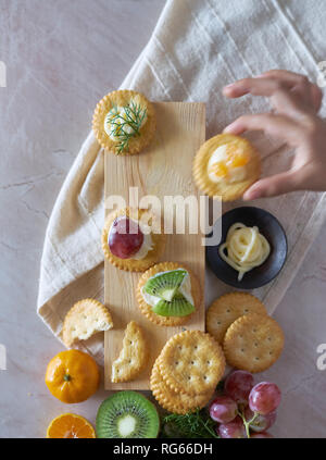 Biscuit Canape serving on wooden board Stock Photo - Alamy