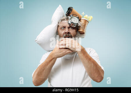 Surprised senior man screaming after sleeping at home or office having ...