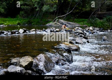 A man refreshes in Broken river, at the Bush camp at The Diggings ...