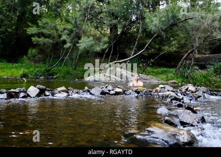 A man refreshes in Broken river, at the Bush camp at The Diggings ...