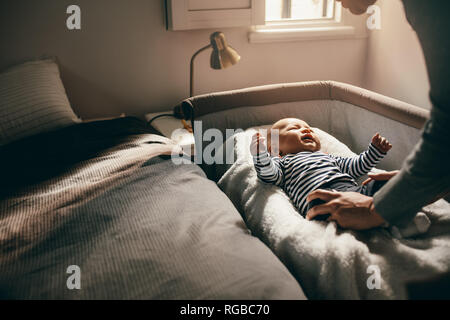 Mother attending her crying baby Stock Photo - Alamy