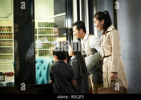 Children looking in shop window Stock Photo - Alamy