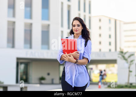 Portrait of student with backpack and notebooks on pink background ...