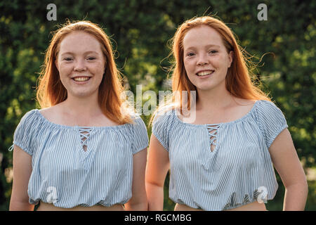 Laughing redheaded twins Stock Photo - Alamy