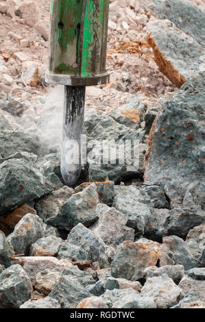 Deconstruction site. Hydrolic rock breaker destroying concrete ...