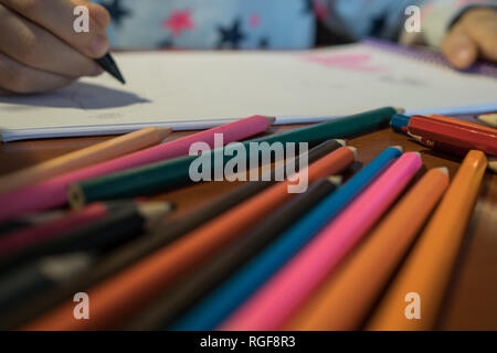 Colored pencils and markers scattered on the table Stock Photo - Alamy
