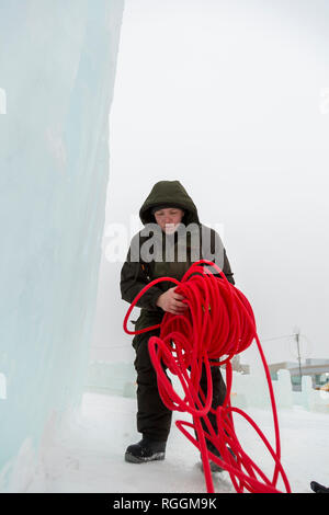 Electrician mounts power cable to illuminate ice figures Stock Photo ...
