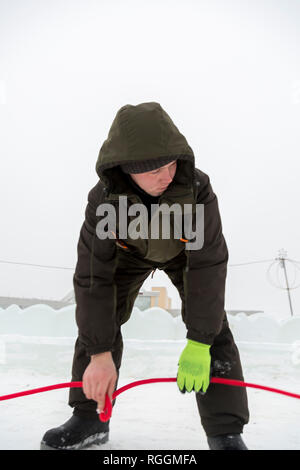 Electrician mounts power cable to illuminate ice figures Stock Photo ...
