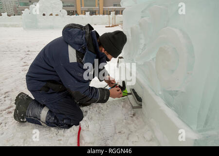 Electrician mounts LED flashlight to illuminate the ice figure Stock ...