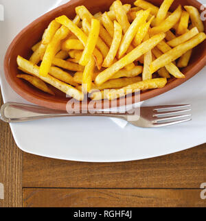 Oval clay plate of french fries on a wooden table, top view Stock Photo ...