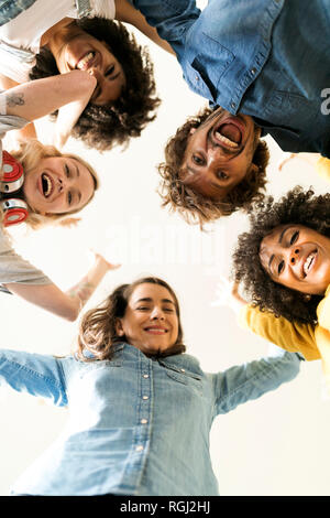 Group portrait of cheerful friends huddling Stock Photo - Alamy
