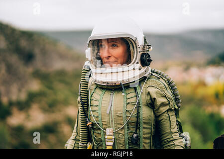 Portrait of the adult female astronaut looking at planet earth - Space ...