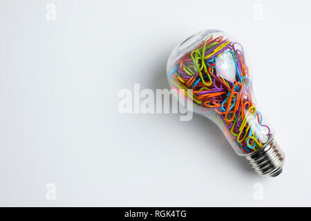 Light bulb filled with colorful paper clips Stock Photo - Alamy
