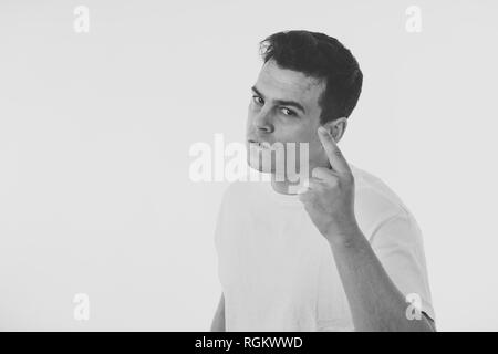 Frustrated man showing fist as angry gesture isolated on white studio ...