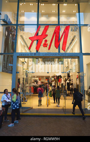 A logo sign outside of a Hennes & Mauritz (H&M) retail store in Munich ...