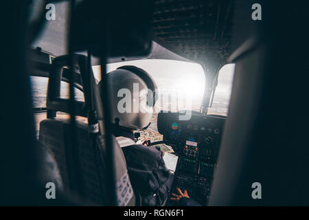 Police pilot during the helicopter flight Stock Photo - Alamy