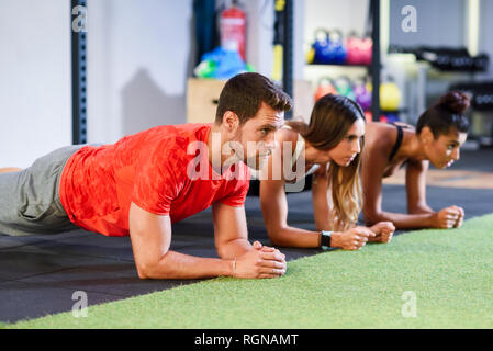 Group of young sporty people concentrate training yoga at sport center ...