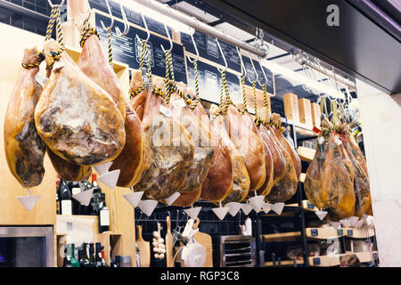 Cured Pork Hams hanging from the ceiling of a butcher's shop in England ...